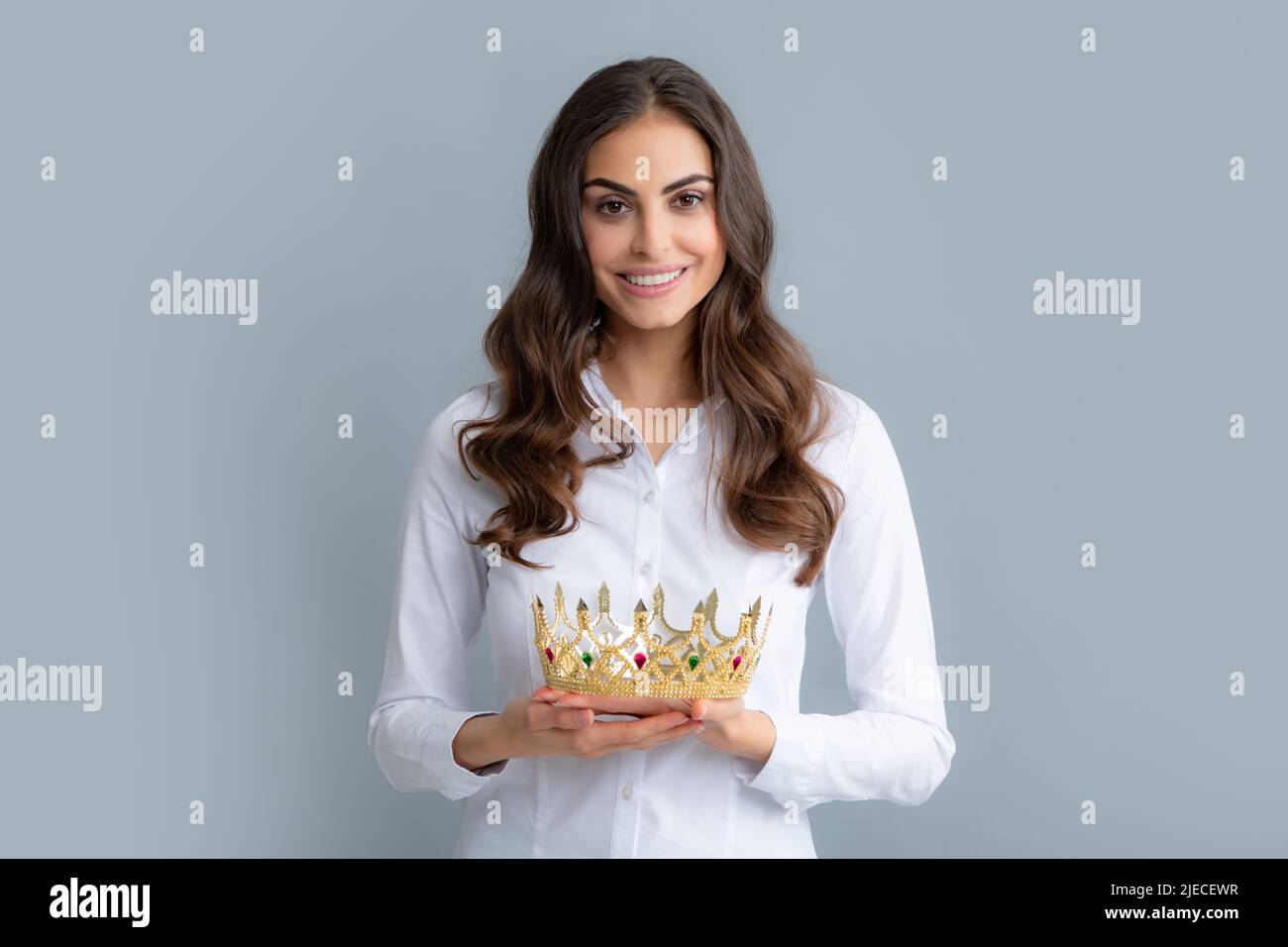 Pretty young woman wear crown, isolated on gray background. Girl with ...