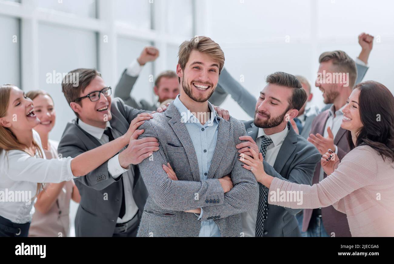 close up. cheerful company employees applauding their colleague Stock ...