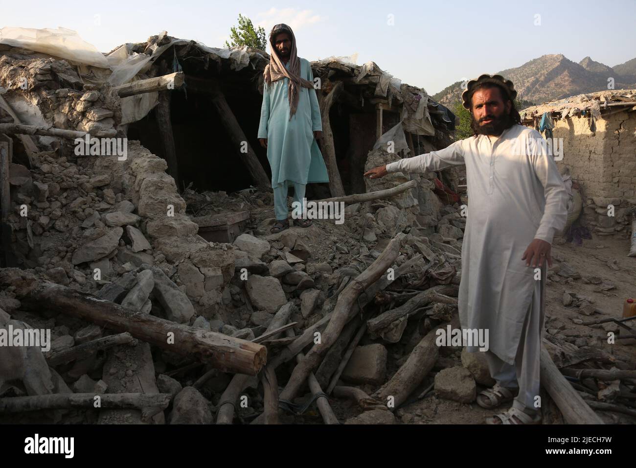 Khost, Afghanistan. 26th June, 2022. People stand on the rubble of a ...