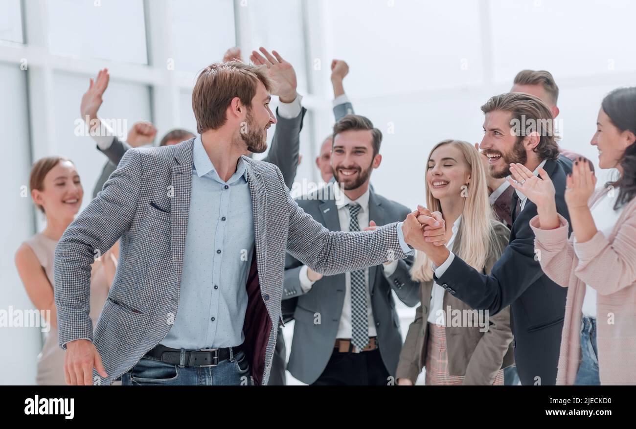 corporate group of employees congratulating their colleague Stock Photo ...
