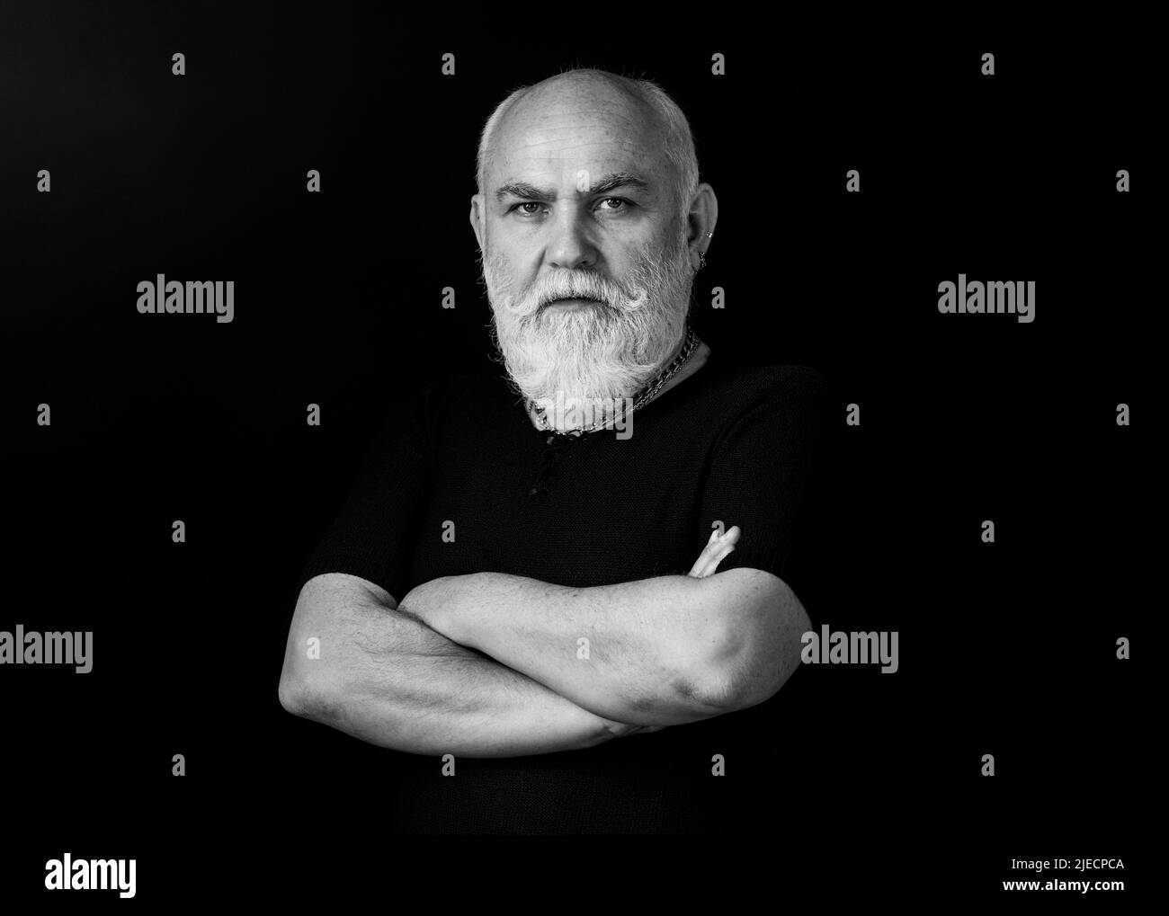 Serious Senior, 70 year old man. Close up low key studio portrait of ...