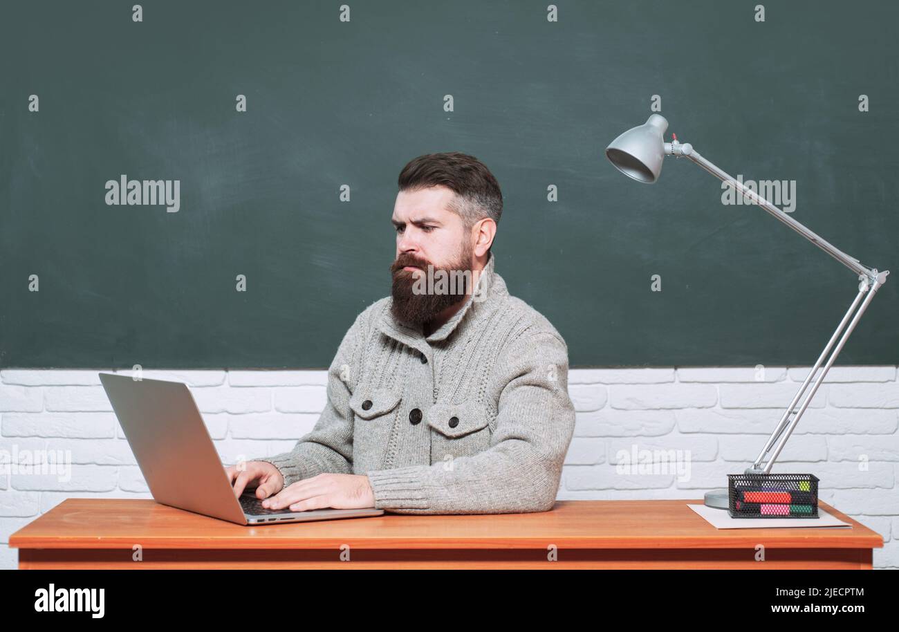 Back to school. Bearded teacher in education class near chalkboard ...