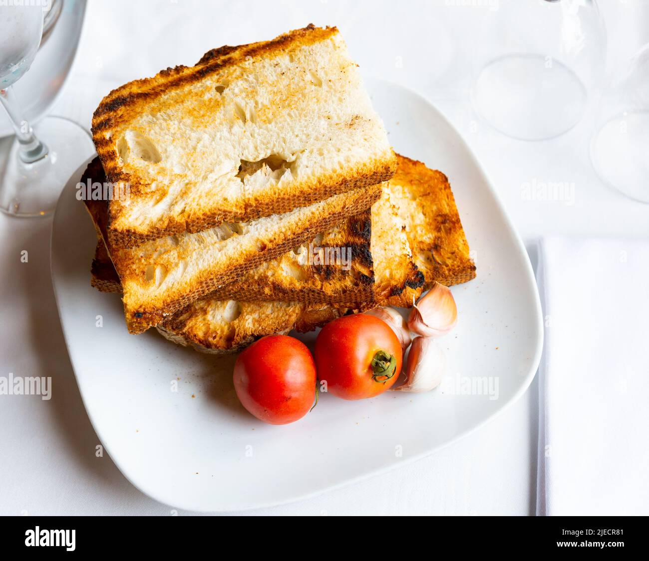 Traditional Catalan food, pan con tomate, served on plate Stock Photo ...