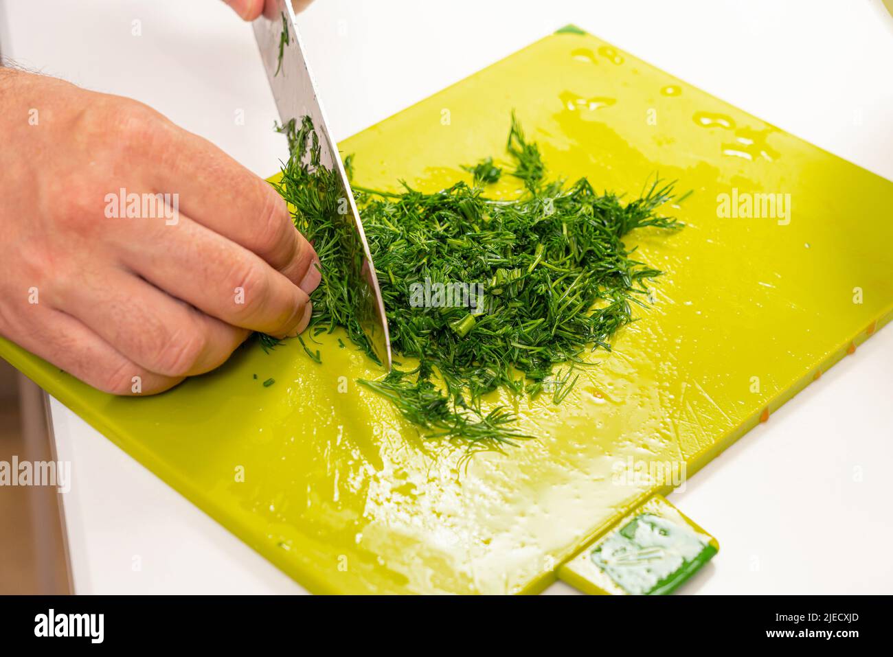 top view cutting dill for making salad with kitchen knife Stock Photo ...