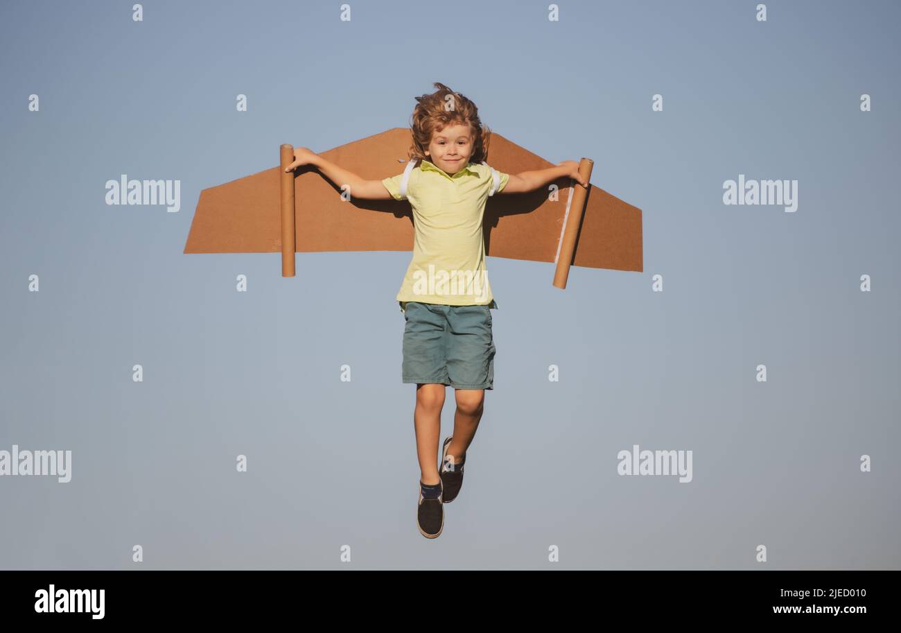 Kids fly. Funny child boy pilot flying with toy cardboard airplane ...