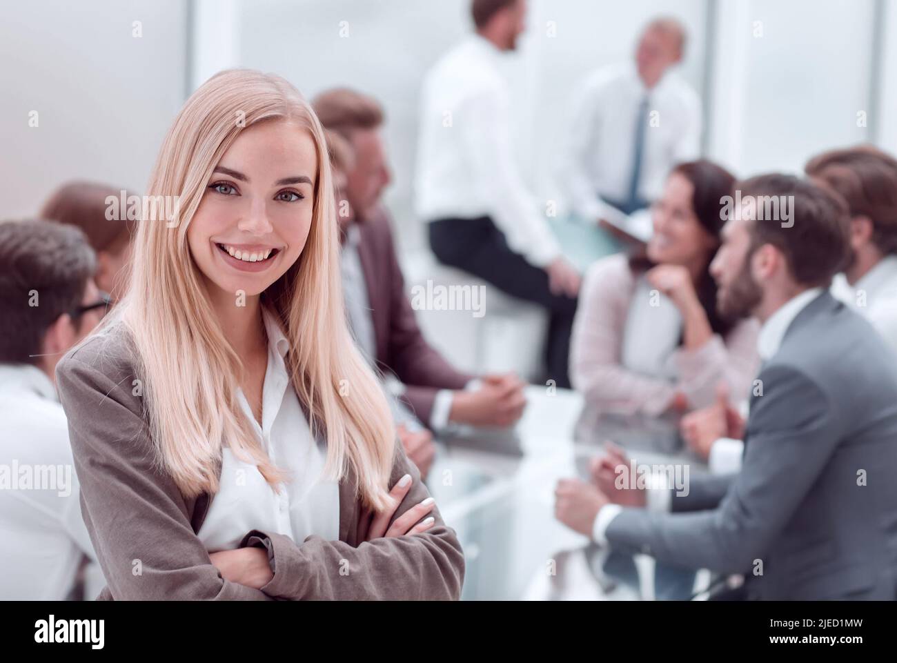 close up. smiling young employee standing in the office Stock Photo - Alamy