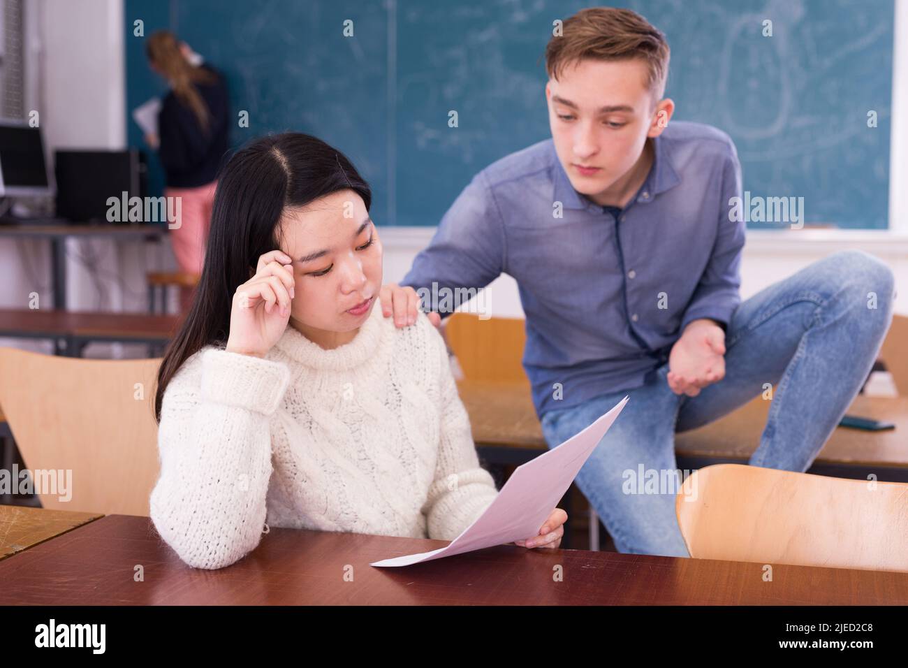 Friend comforting Chinese girl student Stock Photo - Alamy