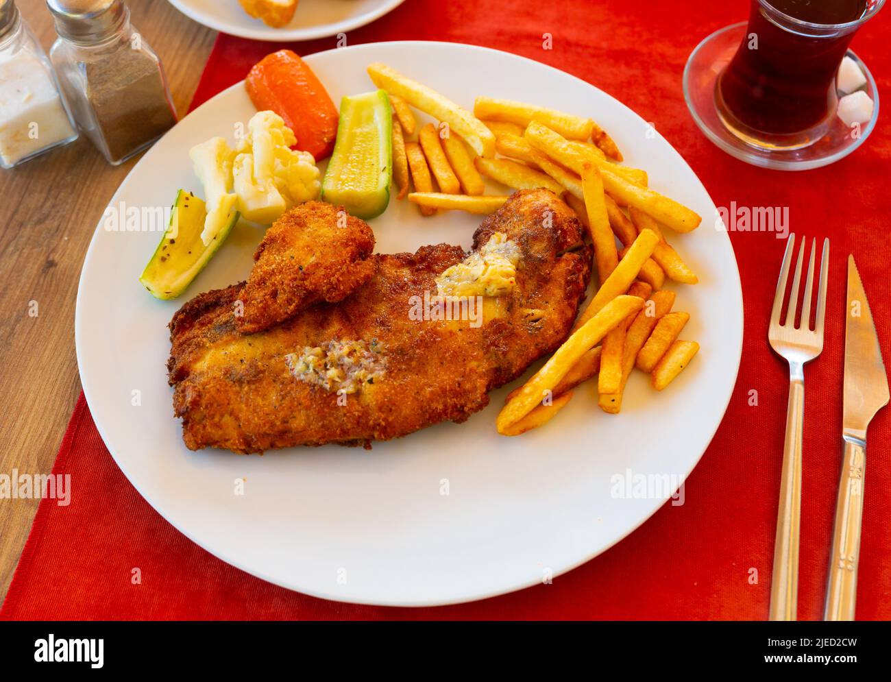 Portion of fried fish fillet with potato and vegetables Stock Photo - Alamy
