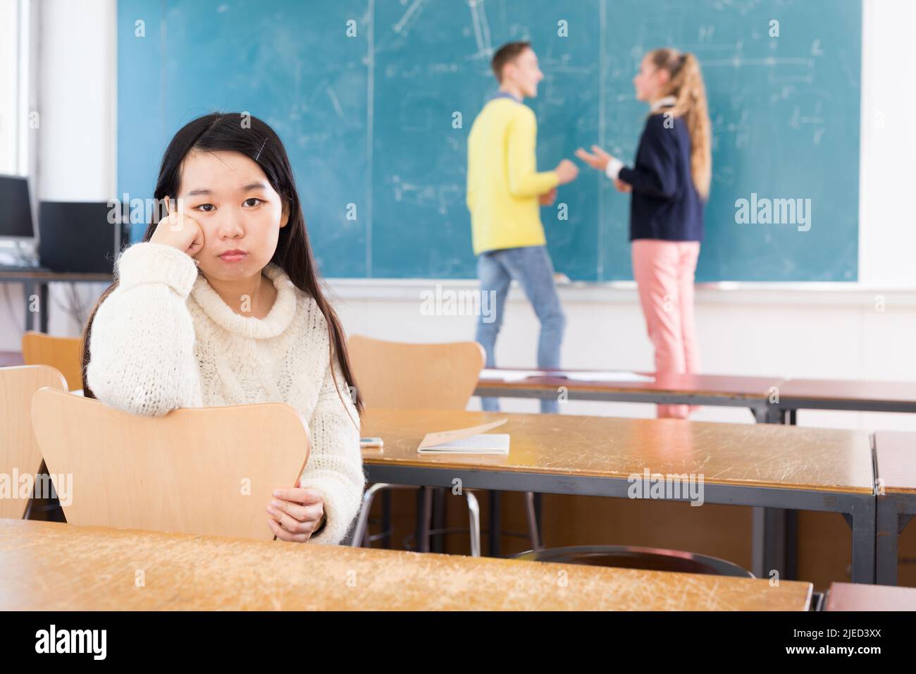 Portrait of unhappy female chinese student in auditorium Stock Photo ...