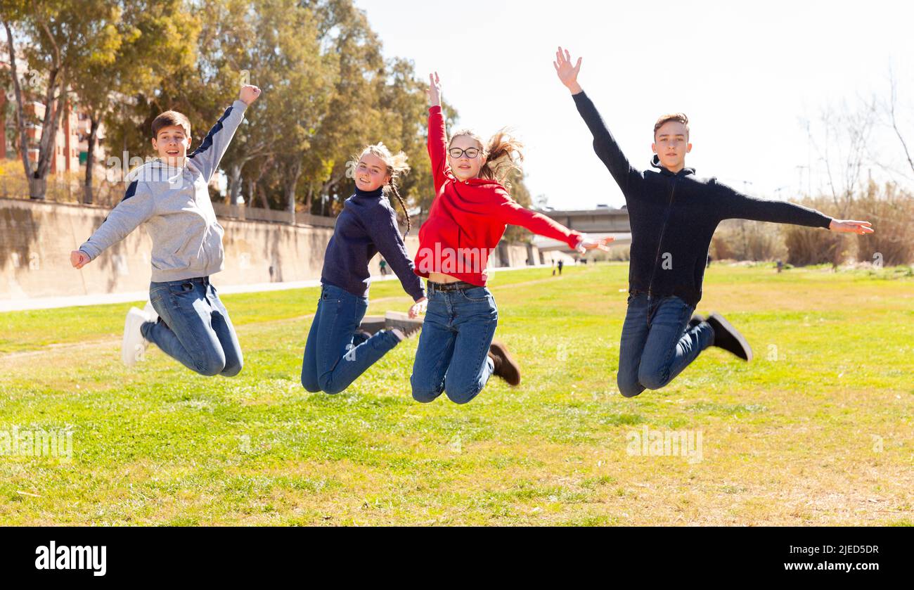 Portrait four happy friends jumping hi-res stock photography and images ...