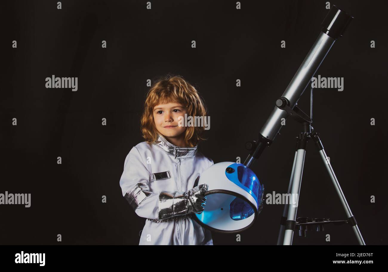 Small child wants to fly an in space, kid boy with telescope wearing an ...