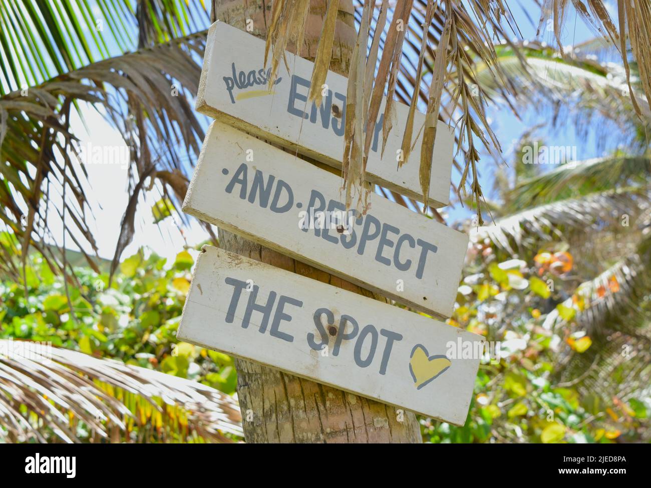 Enjoy and respect the spot signs on Barbados beach Stock Photo - Alamy