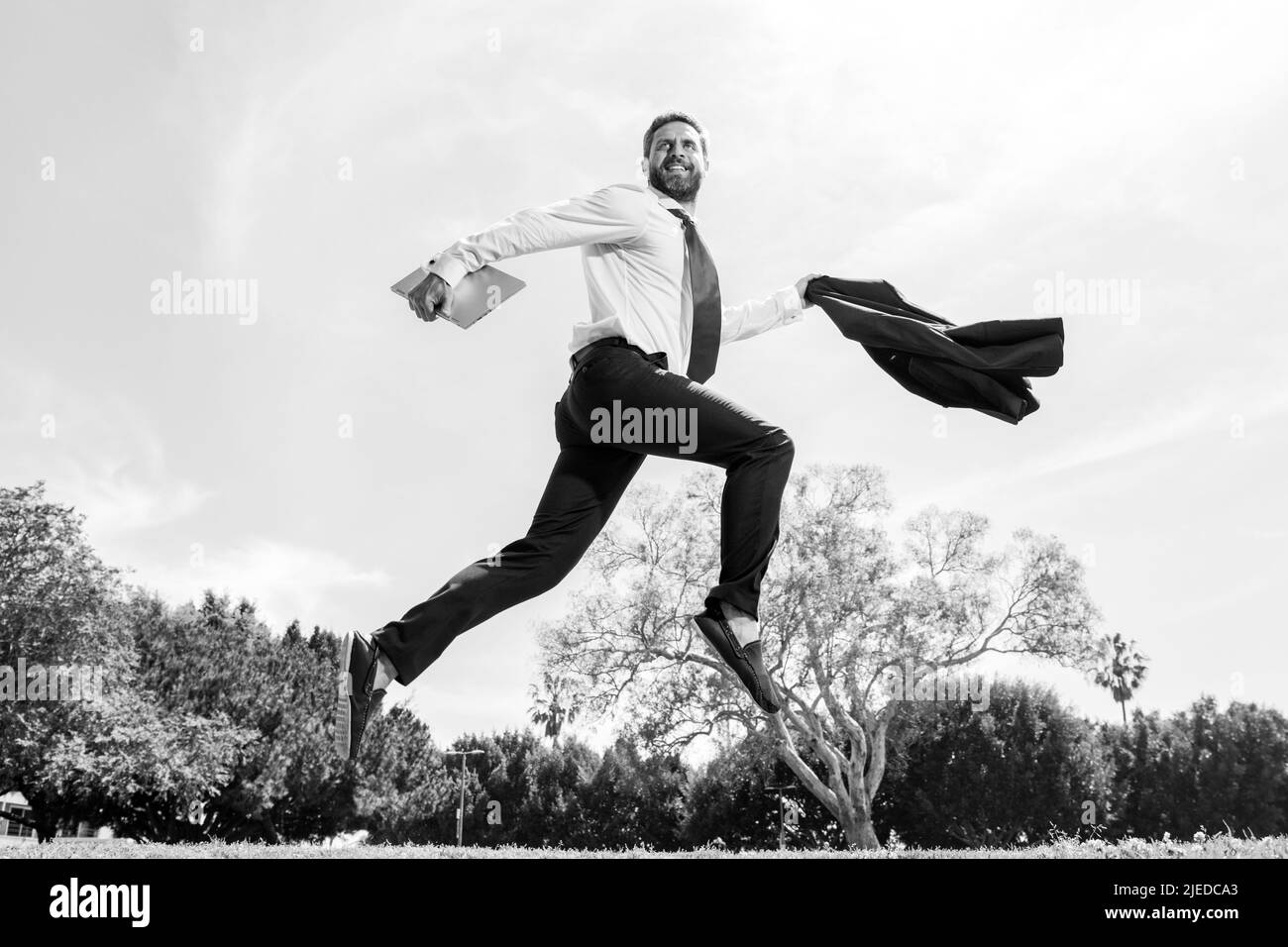 Excited business man running fast, racing and jumping. Portrait of ...