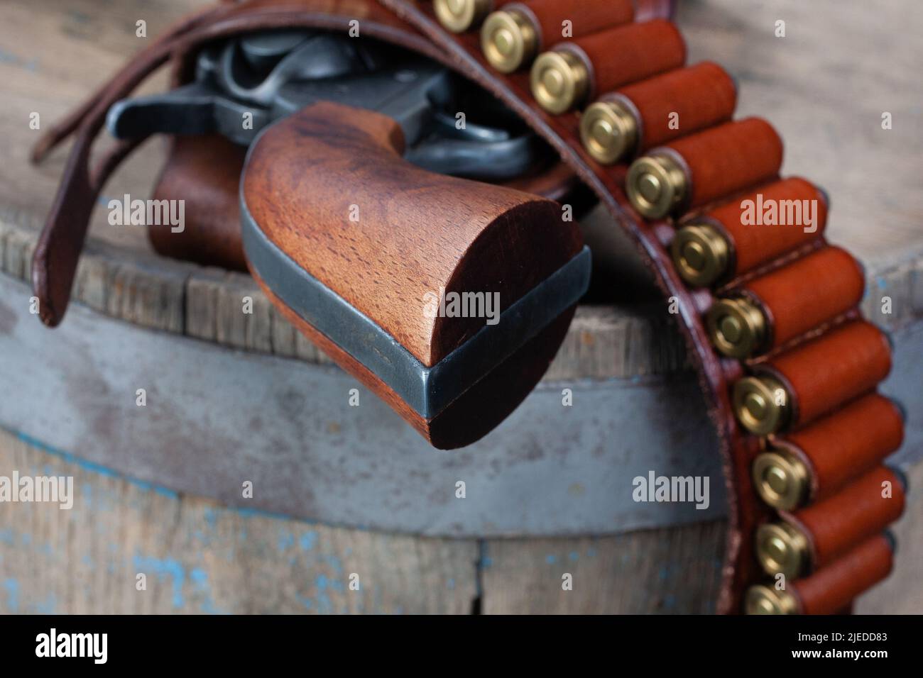 Wild west gun with belt, holster and ammunition on wooden table Stock ...