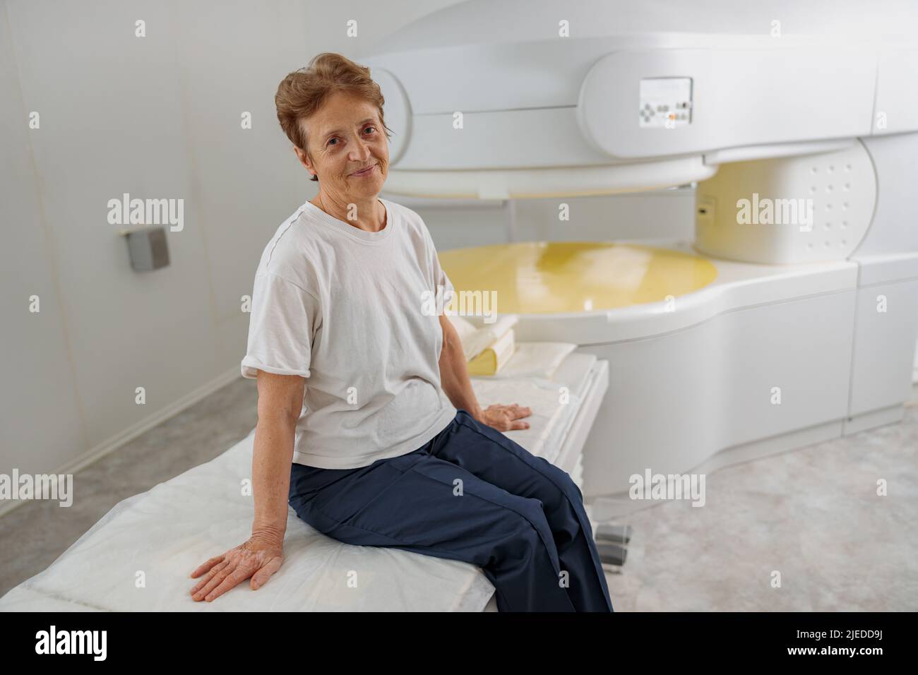 Happy woman patient looking camera after doing procedure of MRI or CT ...