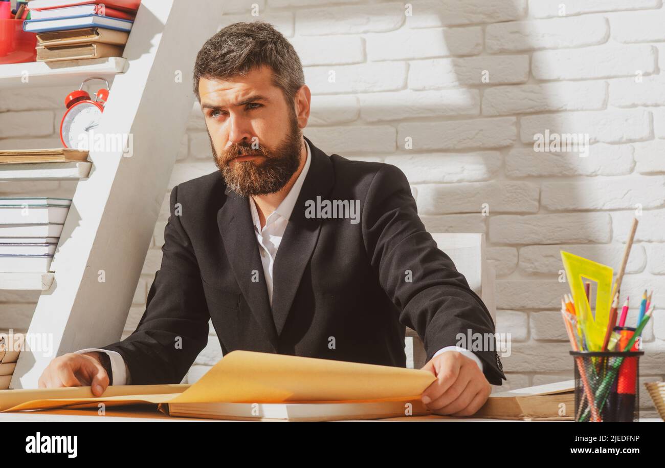 Portrait of serious teacher in school classroom. Tutor, professor ...