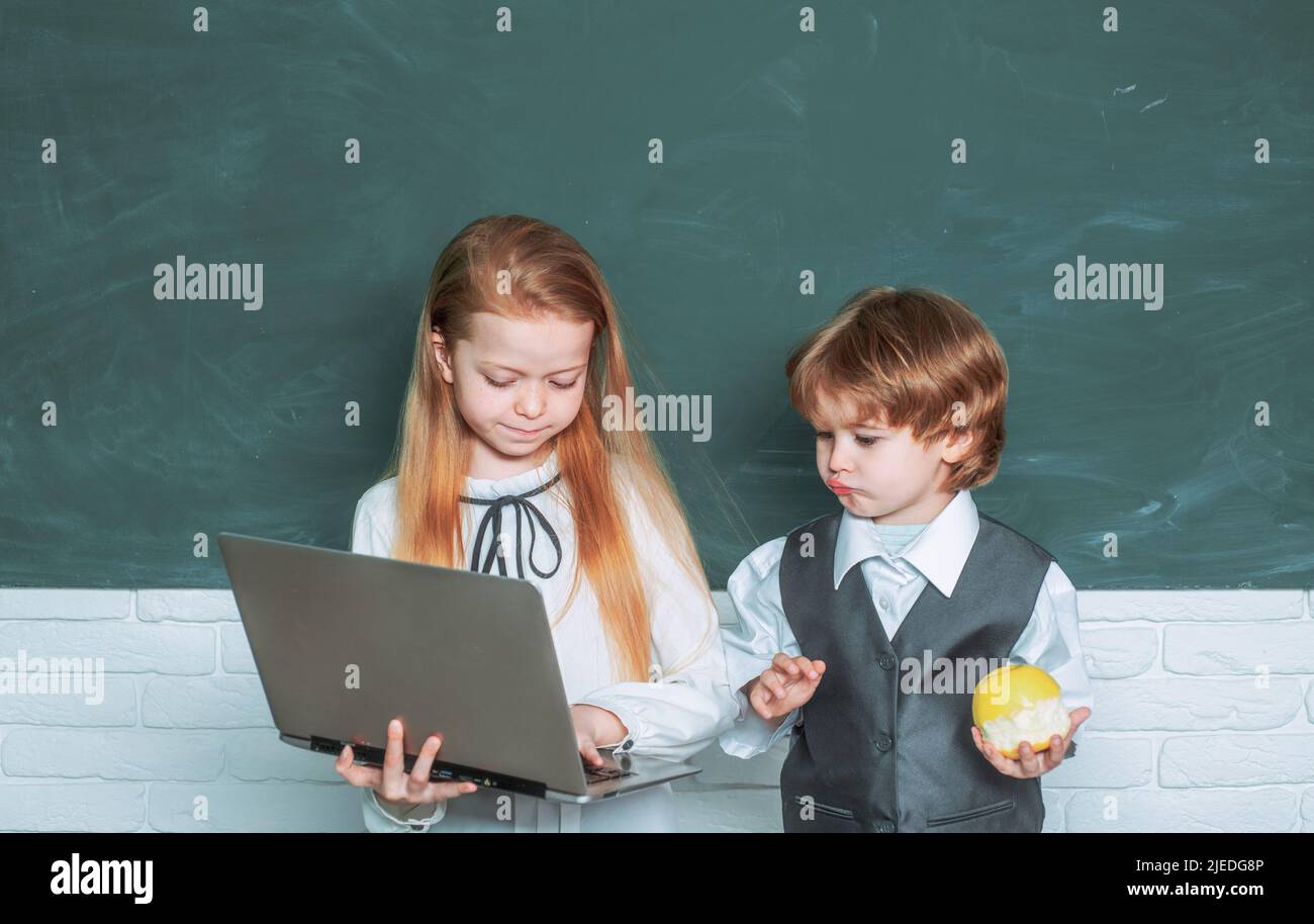 Classroom. First school day. Teacher Schoolgirl helping kids with their ...