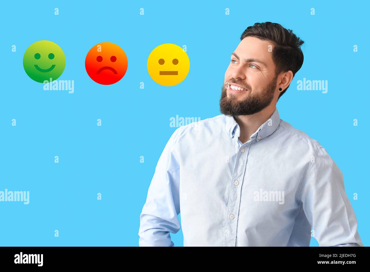 Handsome young man and different emoticons on light blue background ...