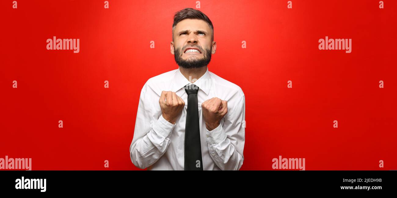 Portrait of aggressive businessman on red background Stock Photo - Alamy