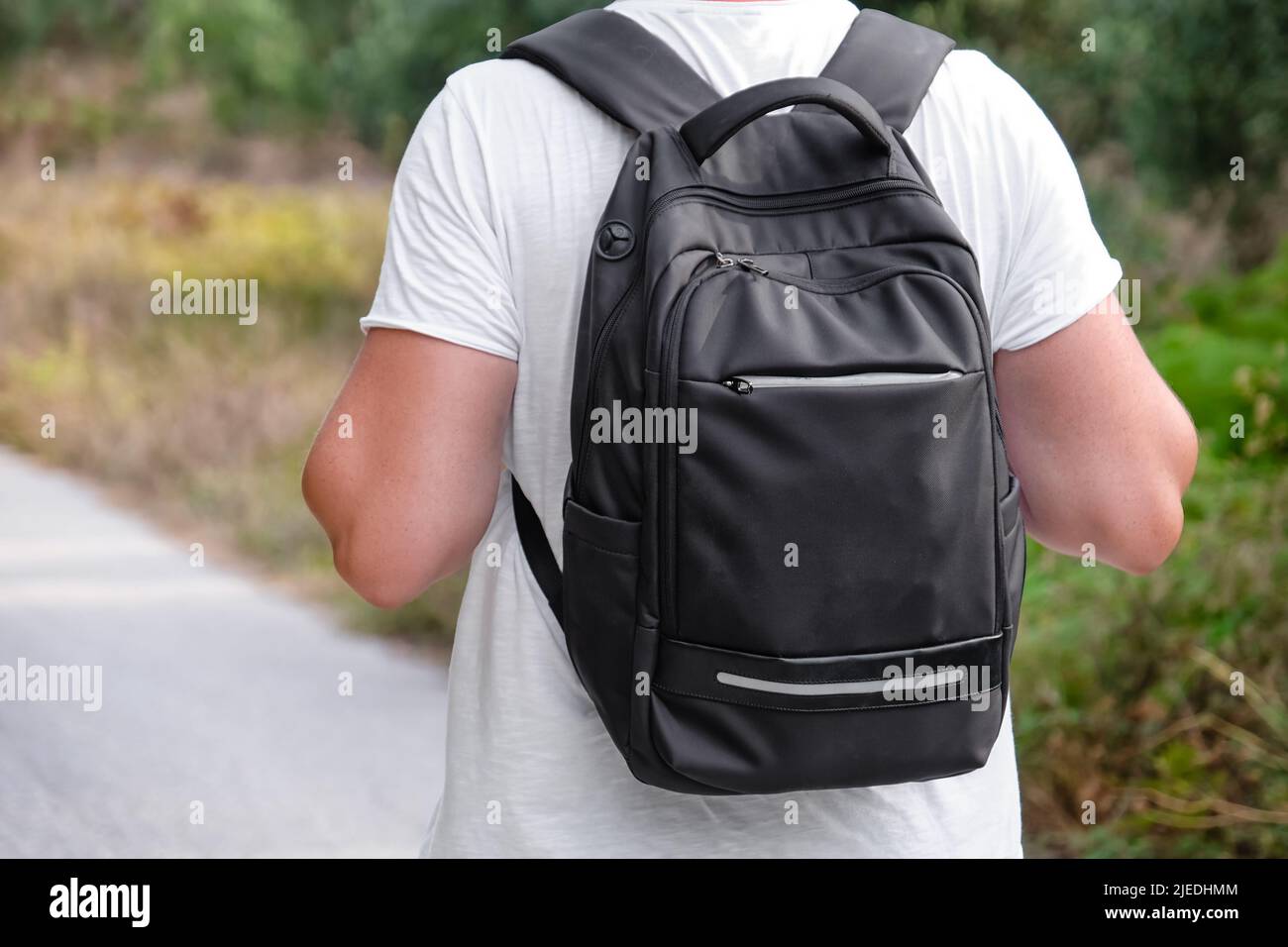 Young male traveler with modern backpack outdoors, back view Stock ...