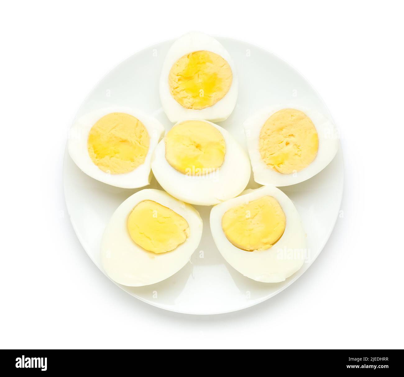 Plate with cut boiled eggs on white background Stock Photo - Alamy