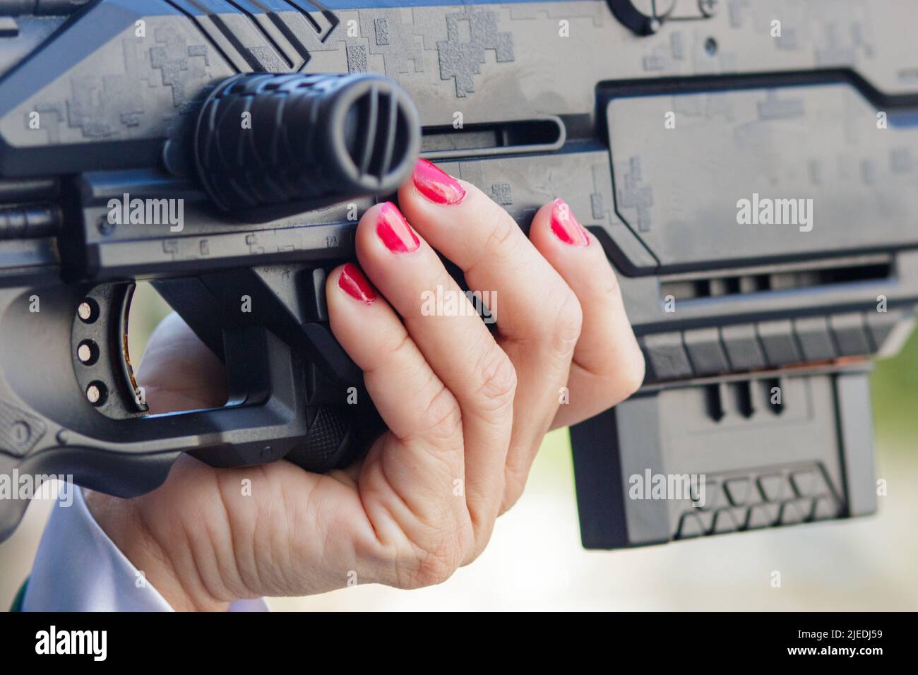 woman with red nails holding a toy gun in Rio de Janeiro Stock Photo ...