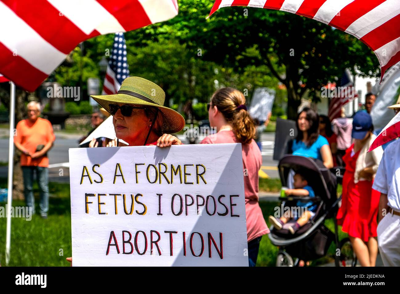 Milford, United States. 26th June, 2022. A woman holds placard that ...