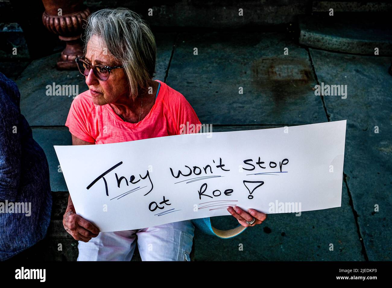 Milford, United States. 24th June, 2022. A woman holds placard that ...