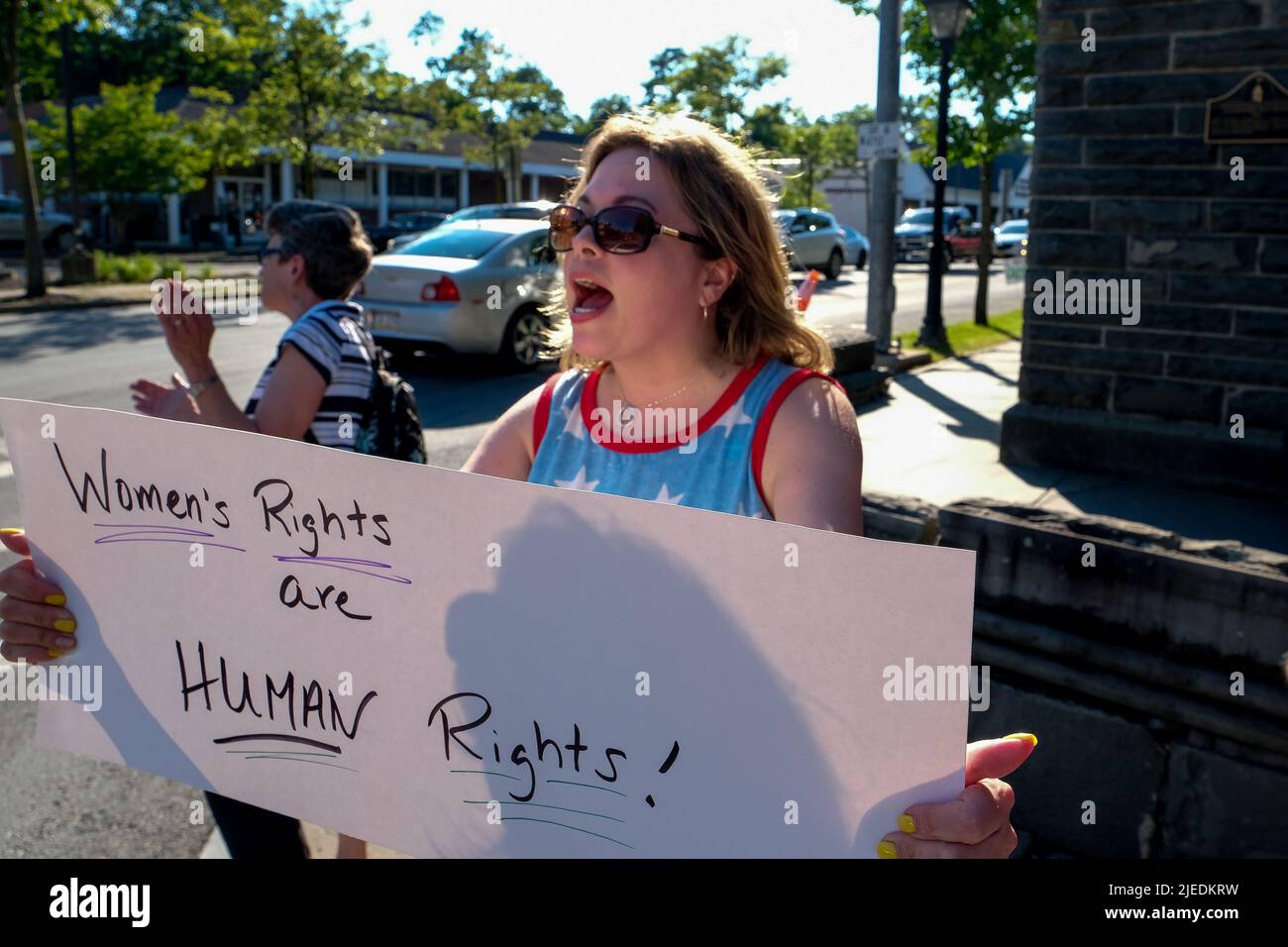 Milford, United States. 24th June, 2022. A woman holds placard that ...