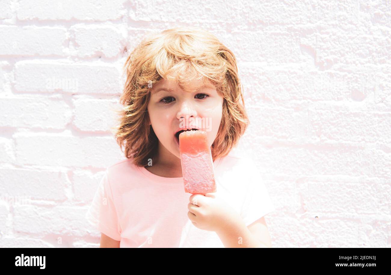 Kids eat pink ice cream. Child eating icecream Stock Photo - Alamy