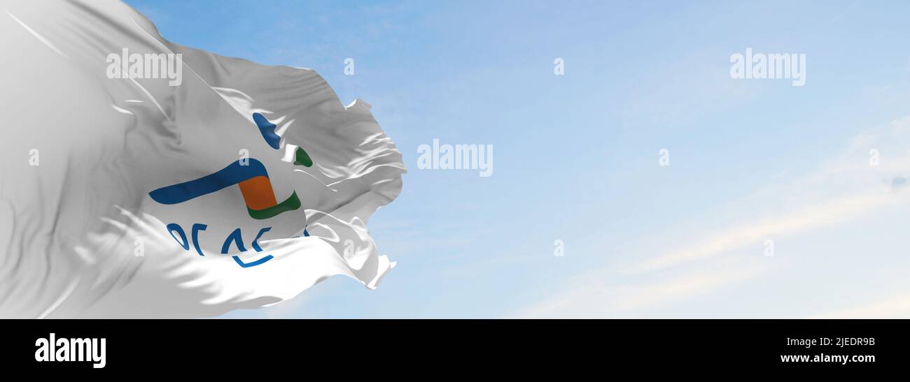 official flag of Asan city, South Korea at cloudy sky background on ...