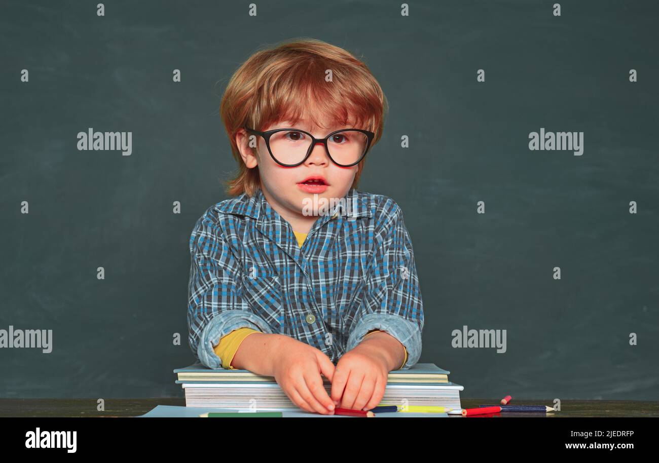 Cheerful smiling child at the blackboard. Ready for school. School ...
