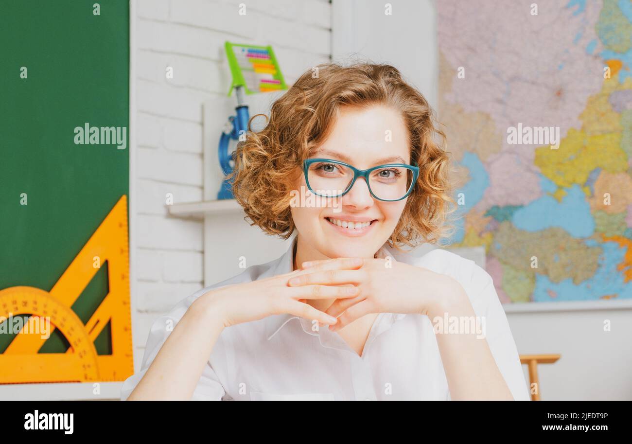 Smiling female teacher. Student learning at classrom in college. Modern ...