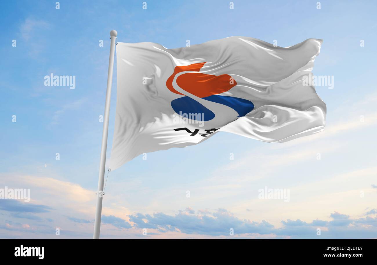 official flag of Siheung city, South Korea at cloudy sky background on sunset, panoramic view ...
