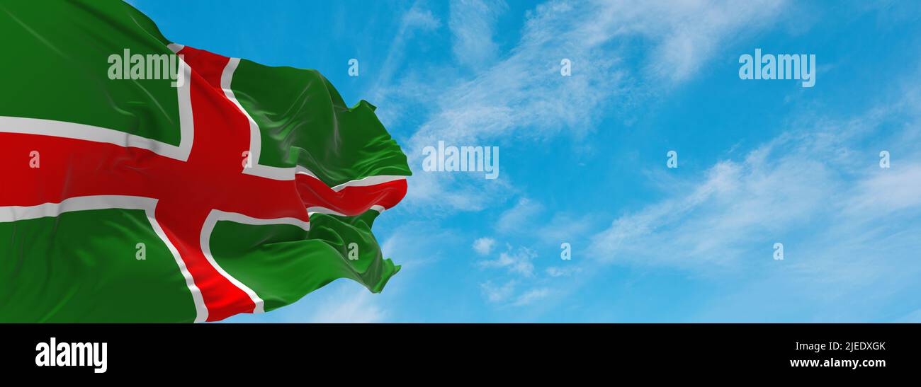 official flag of smaland , Sweden at cloudy sky background on sunset ...