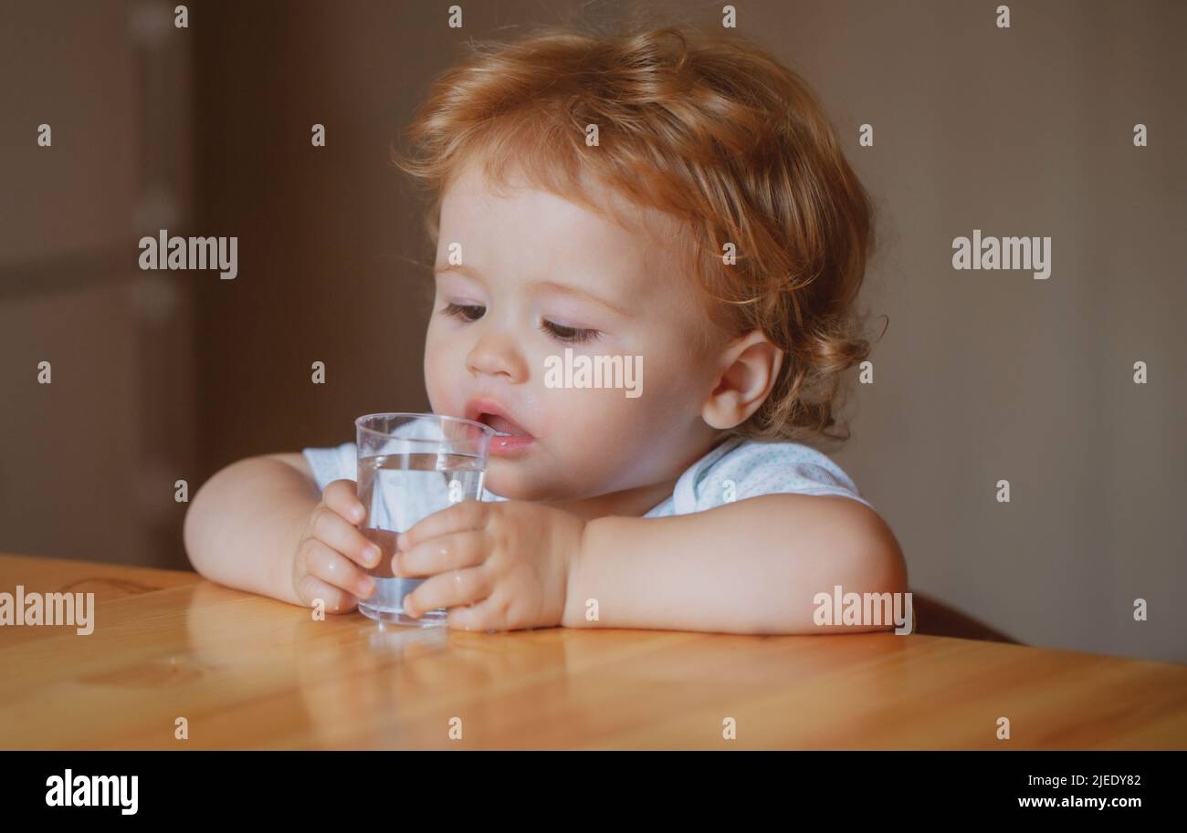 Healthy nutrition for kids. Baby drink water. Portrait of a sweet ...