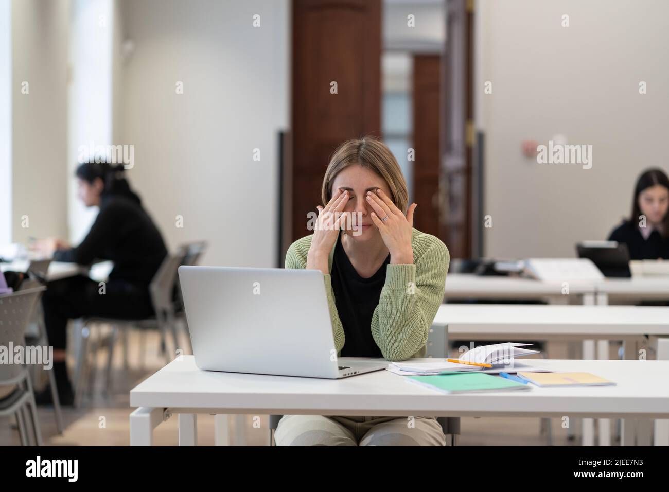 Sleepy tired mature female student feeling exhausted after studying for ...