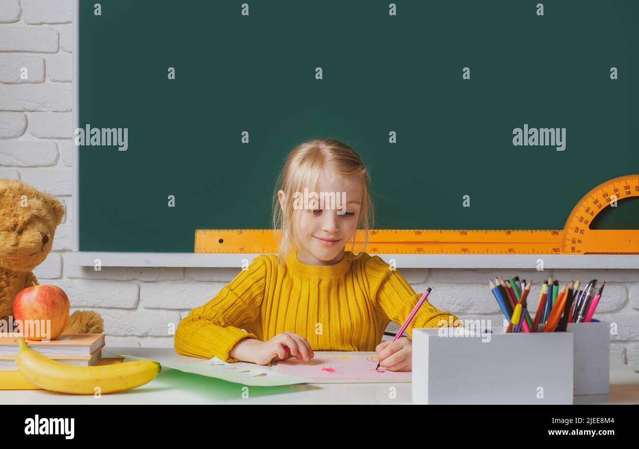 Cute little child studying in classroom at elementary school. Education ...