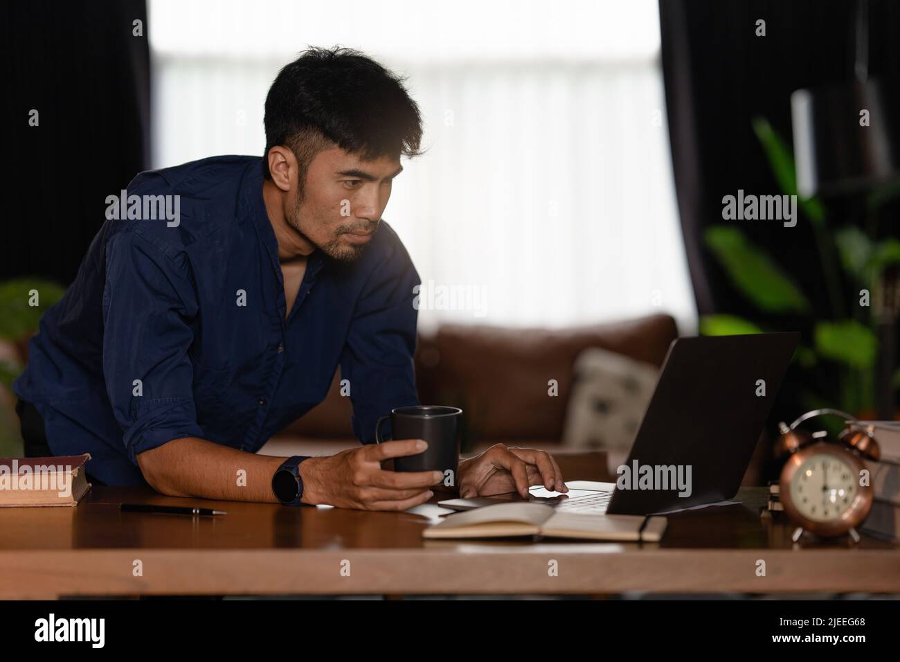 Portrait of Asian Businessman hand using calculator to calculate the ...