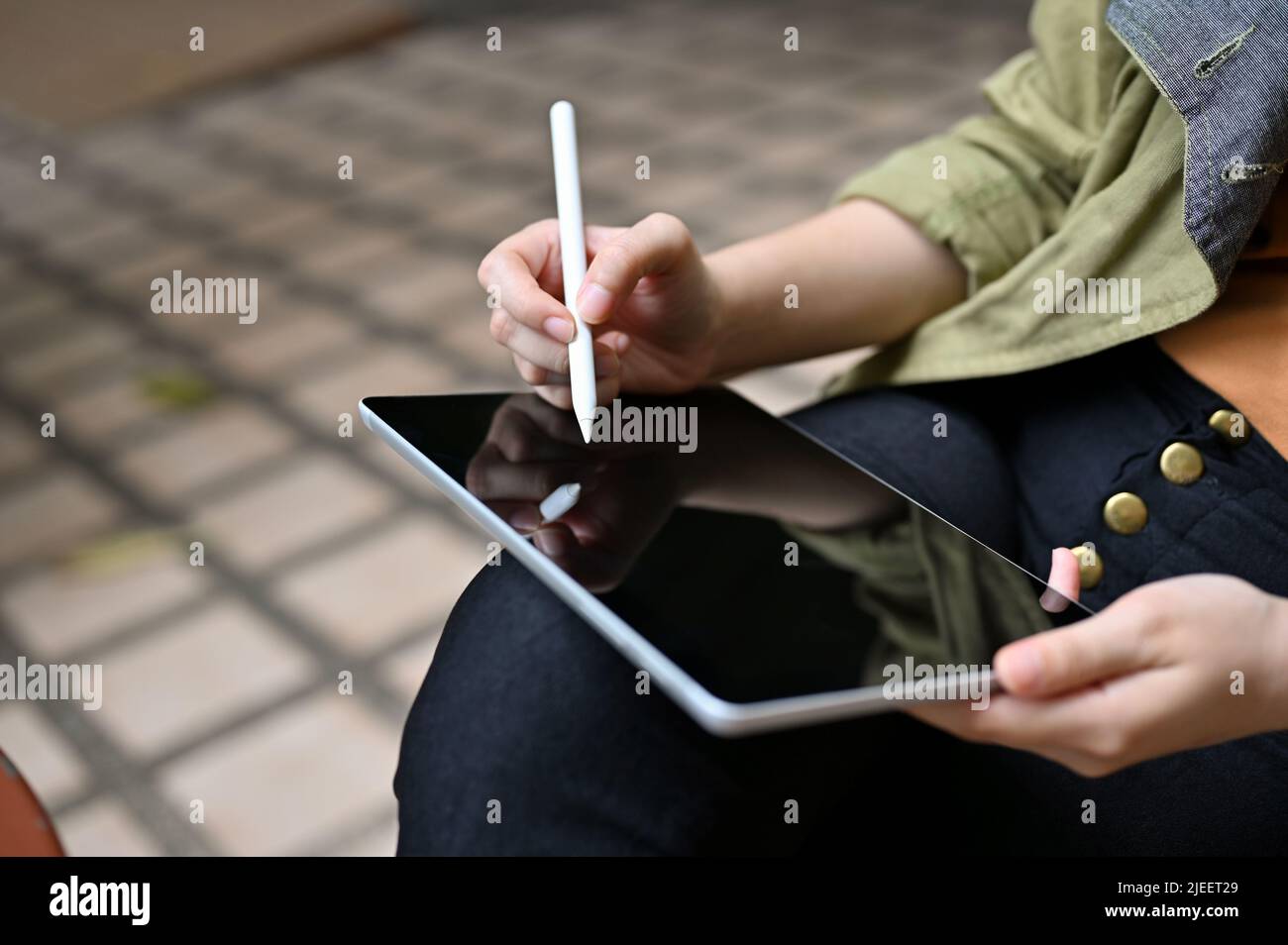 Close-up image, A female using a digital tablet touchpad, using stylus ...