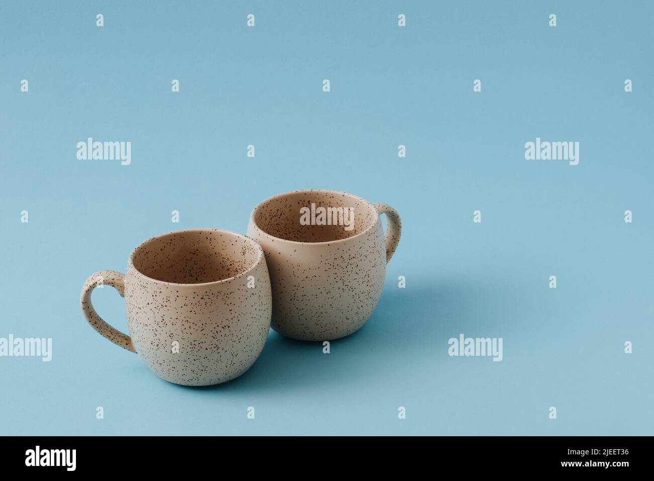 Two porcelain empty cups on a blue background, copy space Stock Photo ...