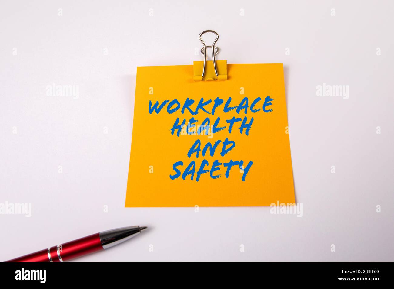 Workplace Health and Safety. Pen and sticky note on a white background ...