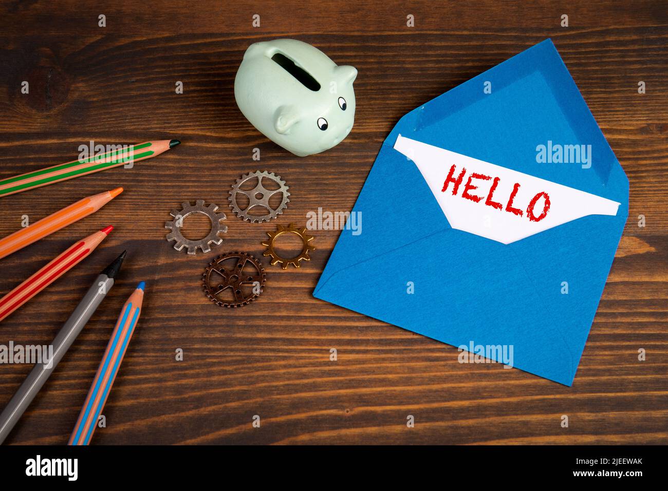 Hello. Blue envelope with text on a brown office desk Stock Photo - Alamy