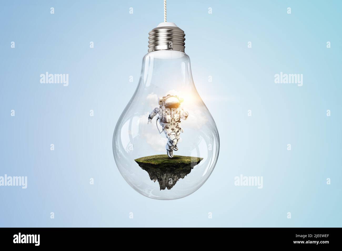 Spaceman inside light bulb . Mixed media Stock Photo - Alamy