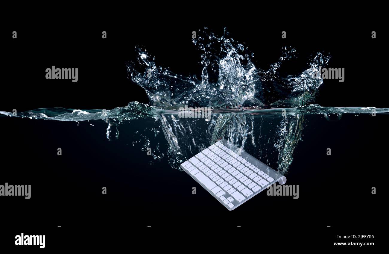 Keyboard dropped into water . Mixed media Stock Photo - Alamy