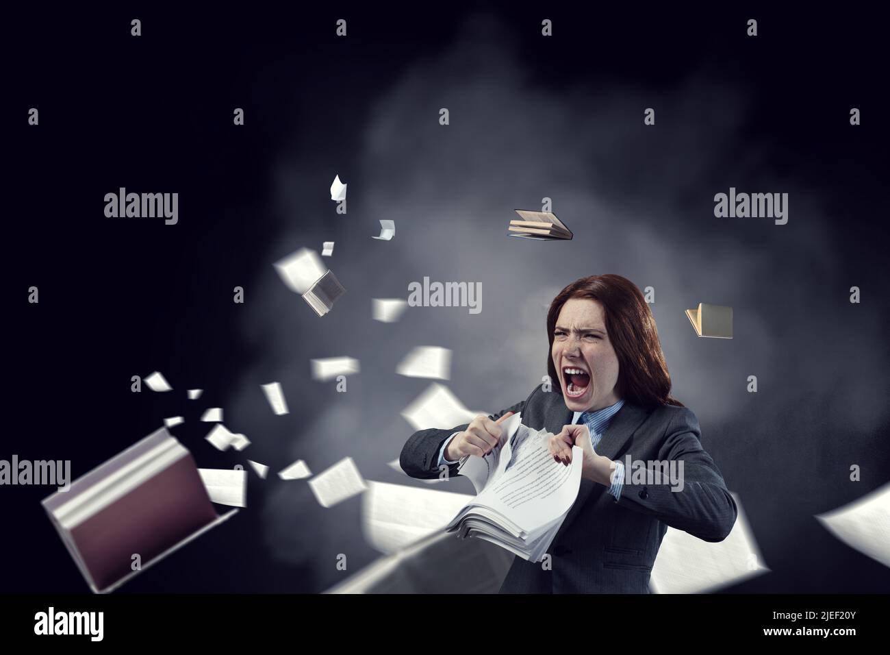 Young stressed woman ripping documents with frustrated facial ...