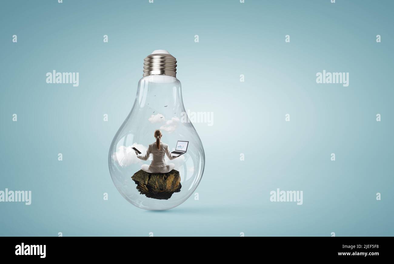 Business woman doing yoga in lotus pose inside light bulb Stock Photo ...