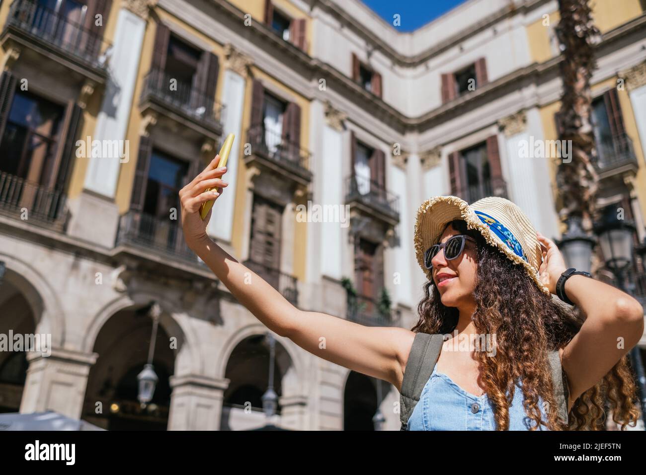 young turkish female traveler wearing a straw hat and sunglasses taking ...