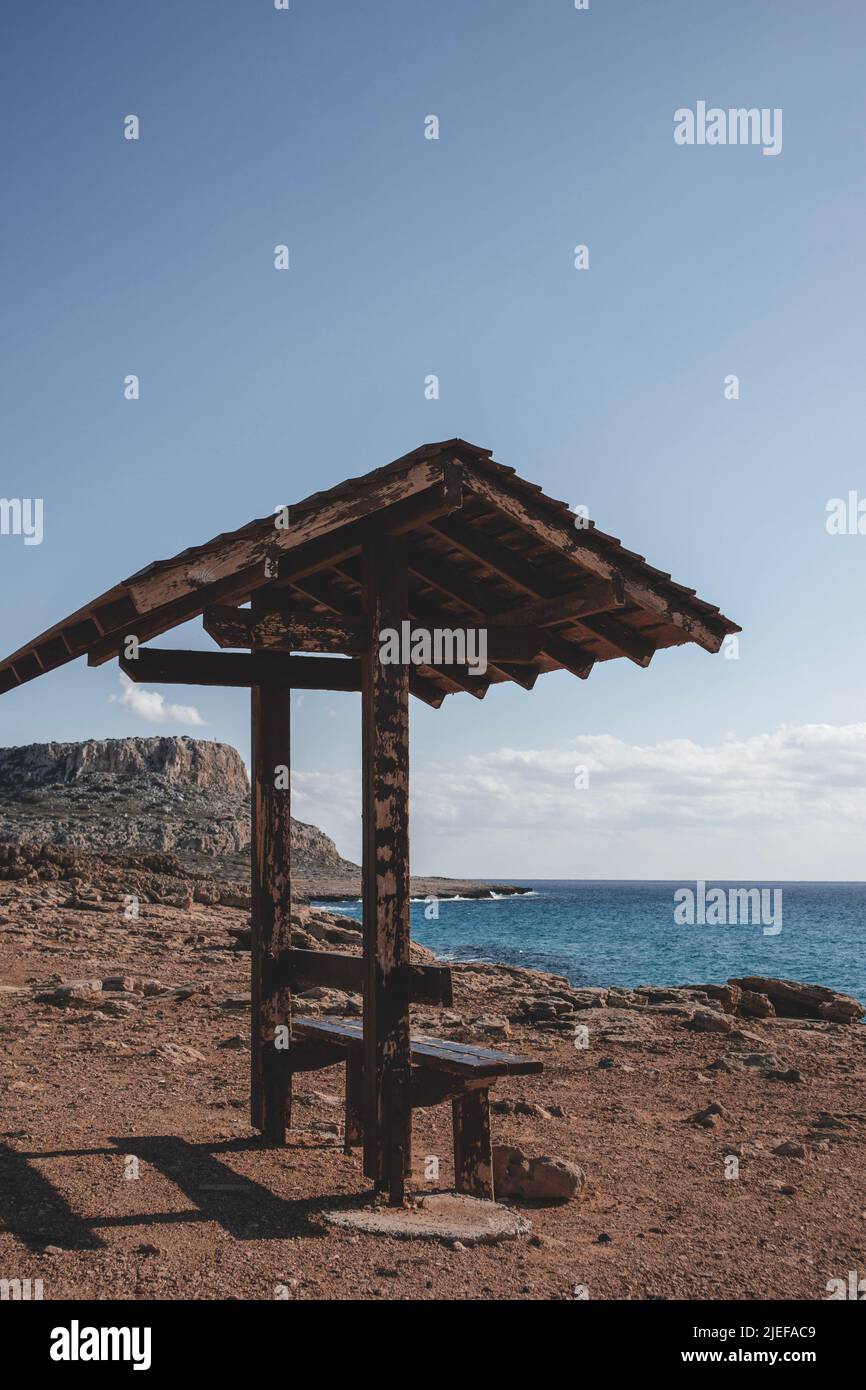 Beautiful seashore with wooden bench with roof on foreground of Cape ...