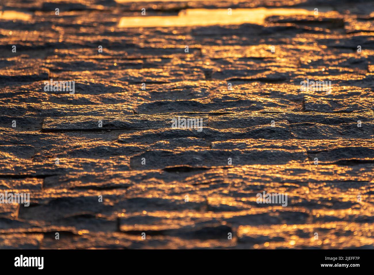 Stone pavement in the rays of the setting sun. Backround of Block ...